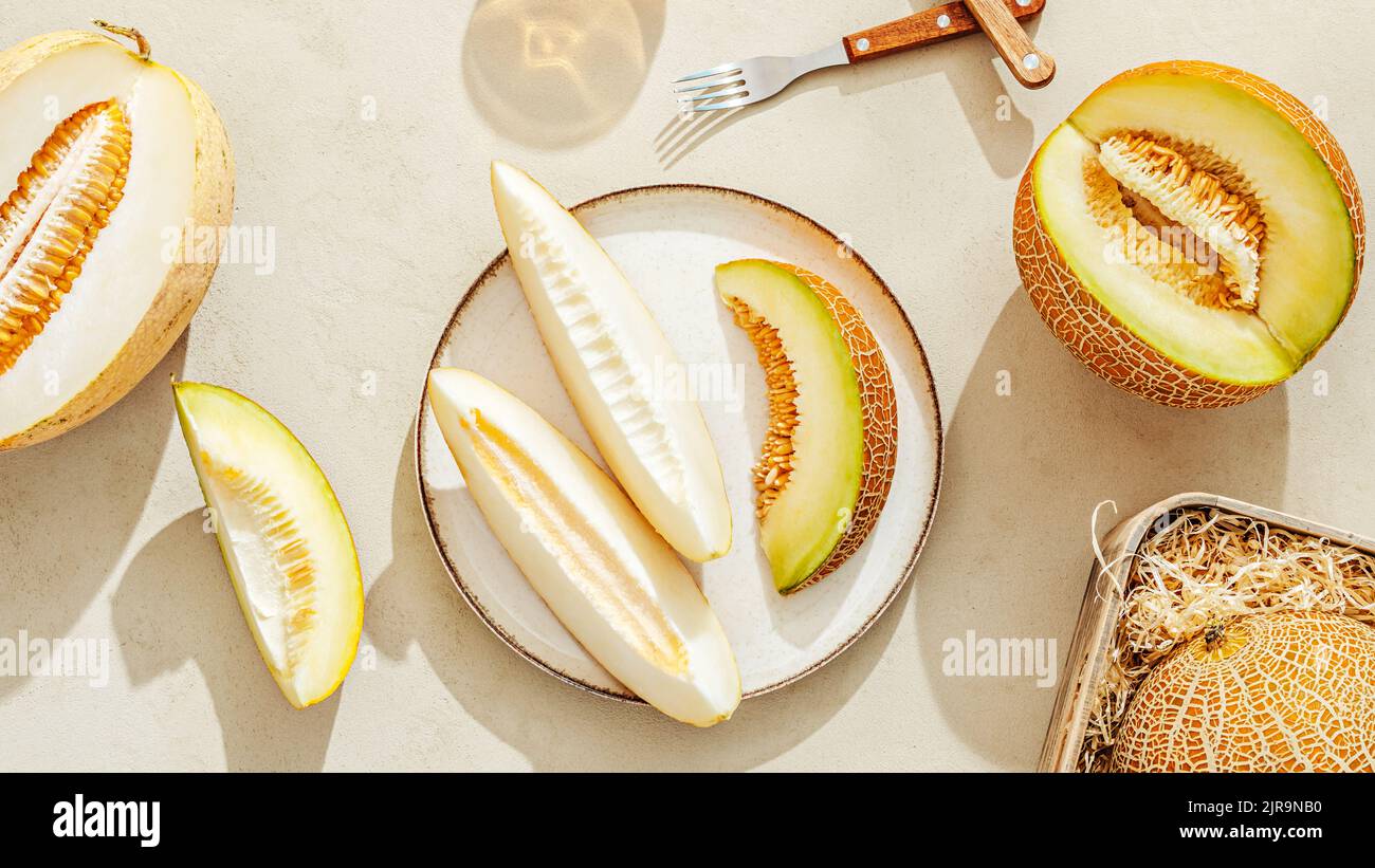 Various sliced melons on a light stone background Stock Photo - Alamy