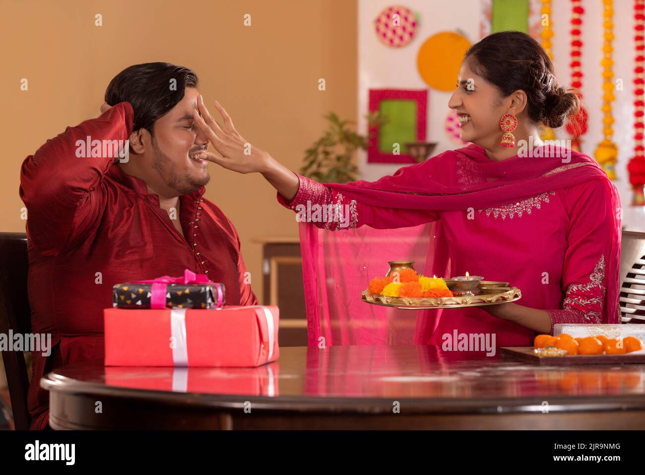 Sister applying tika on her brother's forehead on the occasion of ...