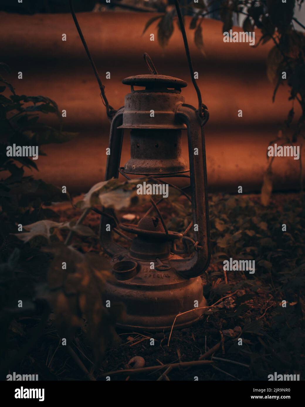 An old rusty fuel lamp on the ground Stock Photo - Alamy