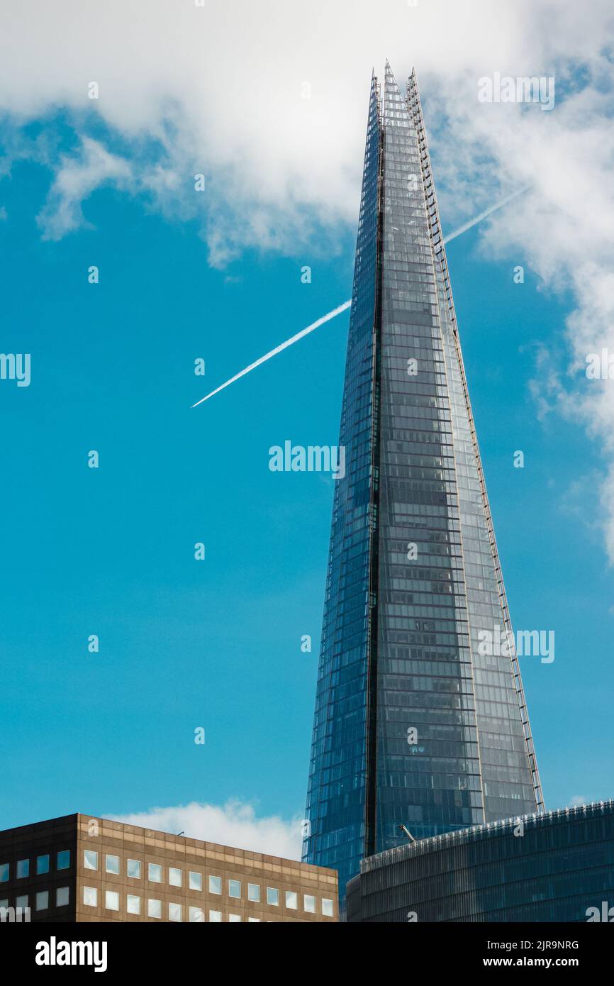 The Shard in London with the trail of a plane in the background Stock ...