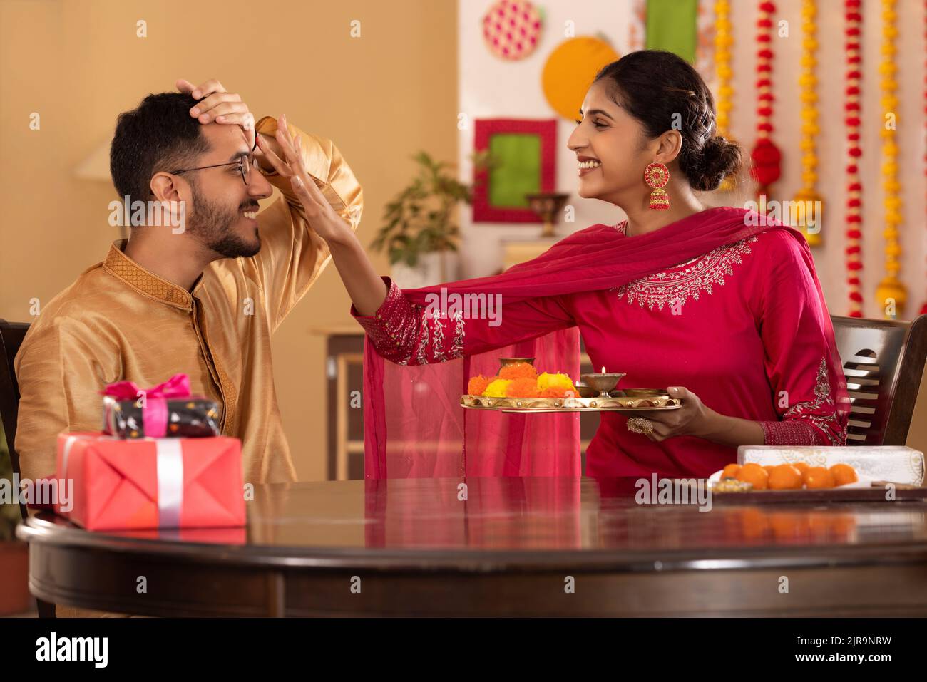 Sister applying tika on her brother's forehead on the occasion of ...
