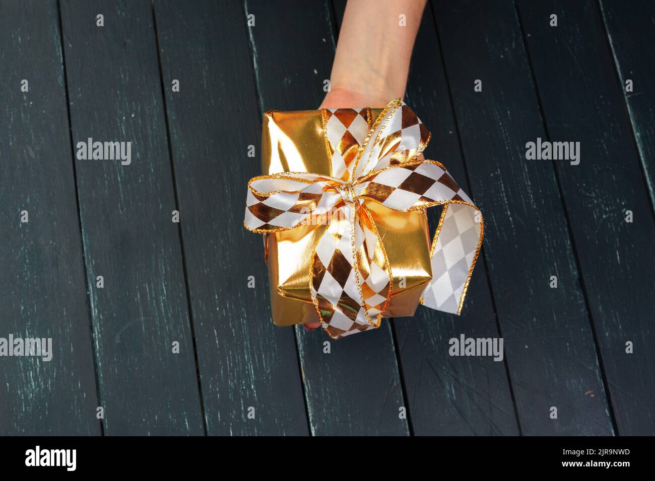 gift box in hand girls on wood table Stock Photo - Alamy