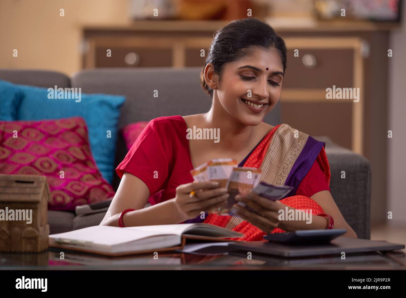 Portrait of young woman counting Indian currency Stock Photo - Alamy