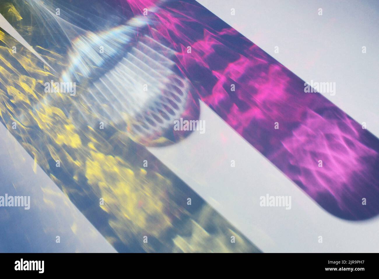 Sunlight through colored glass of water on blue background. Long harsh ...