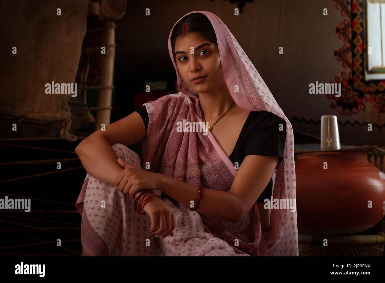 Portrait of happy housewife sitting at home Stock Photo - Alamy