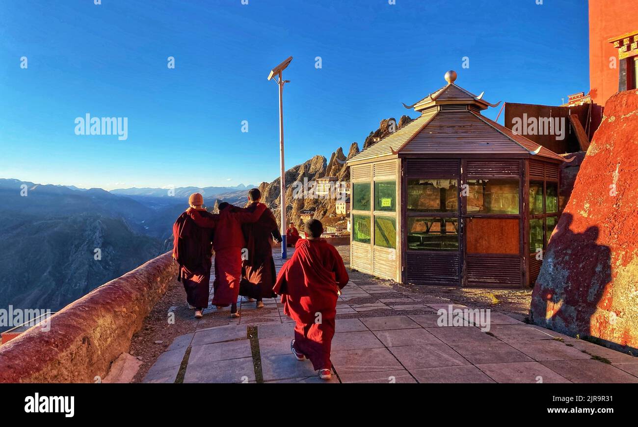 A monk walking in the temple with blue sky background Stock Photo - Alamy