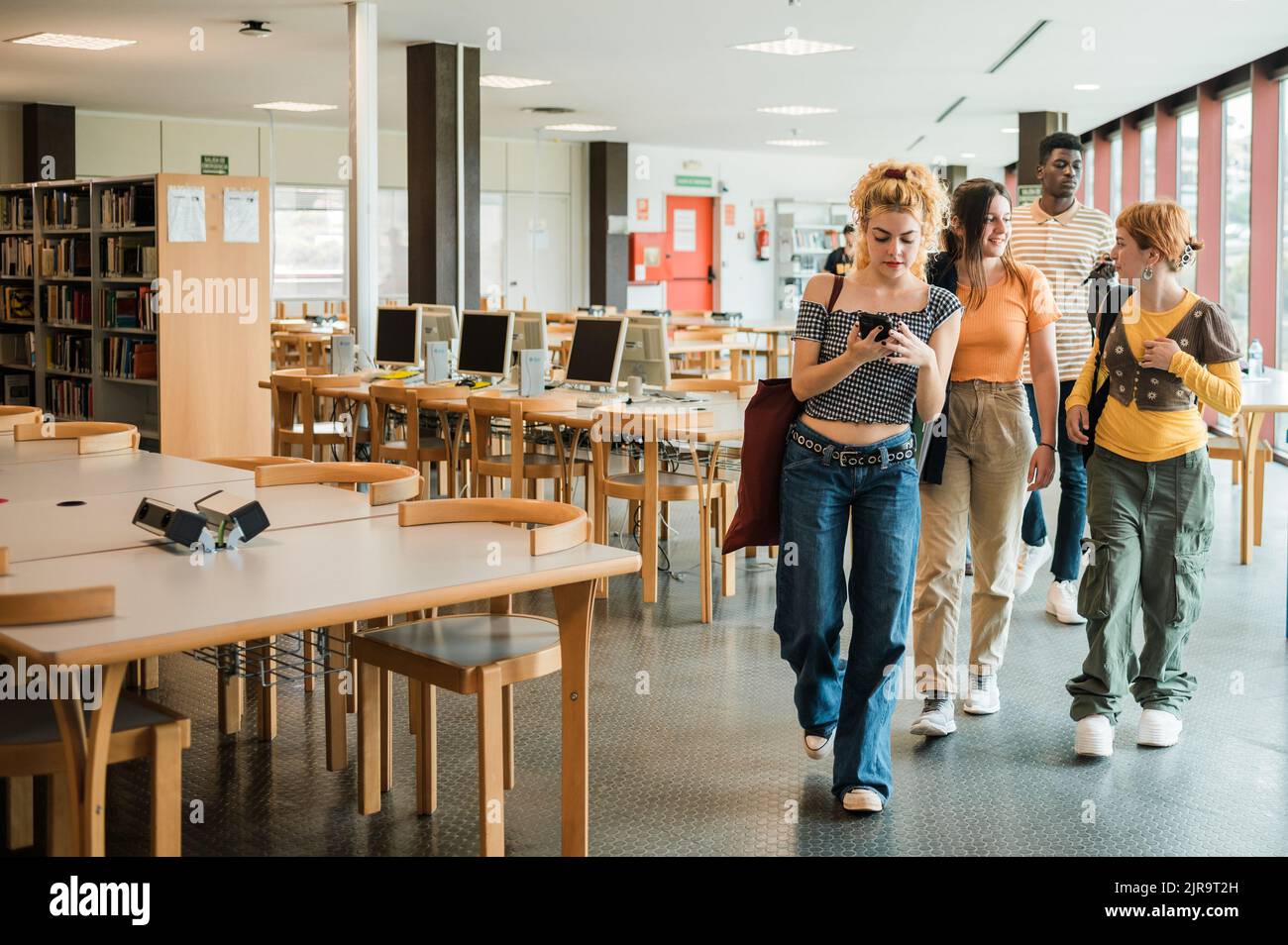 Diverse students leaving library together Stock Photo - Alamy