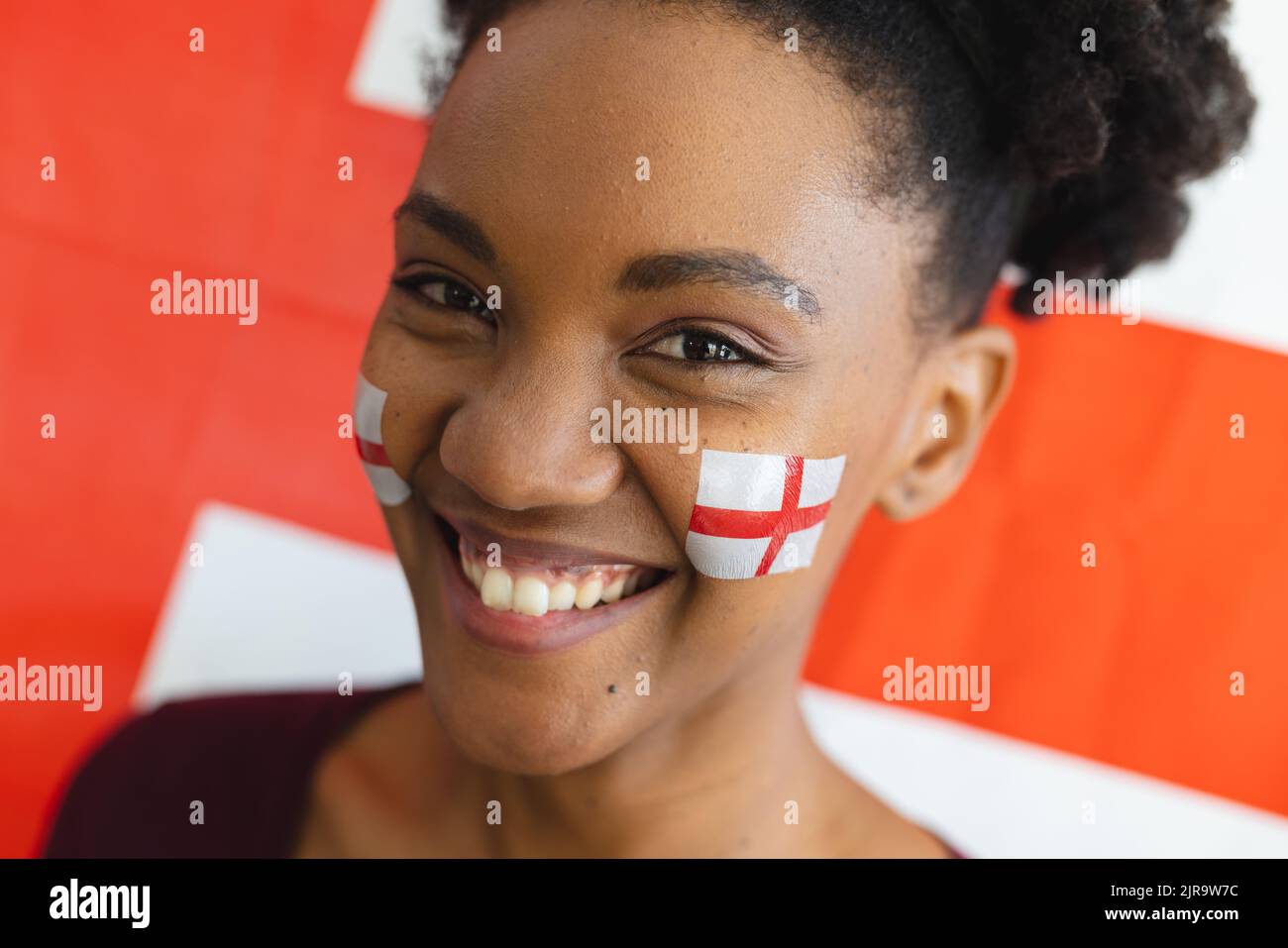 Image of happy african american woman with flags of england on face ...