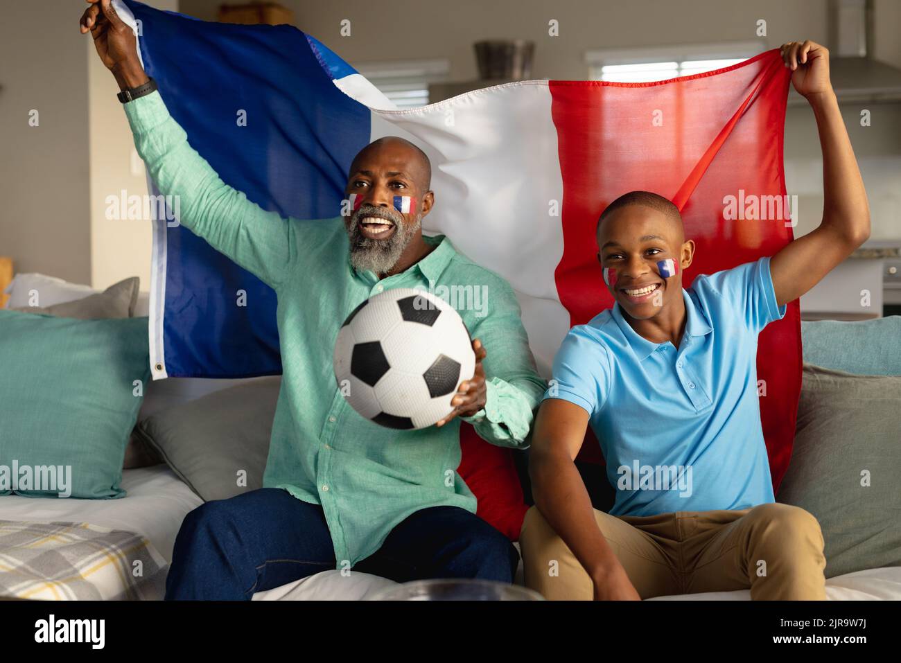 Happy african american male teenager with his father supporting with ...