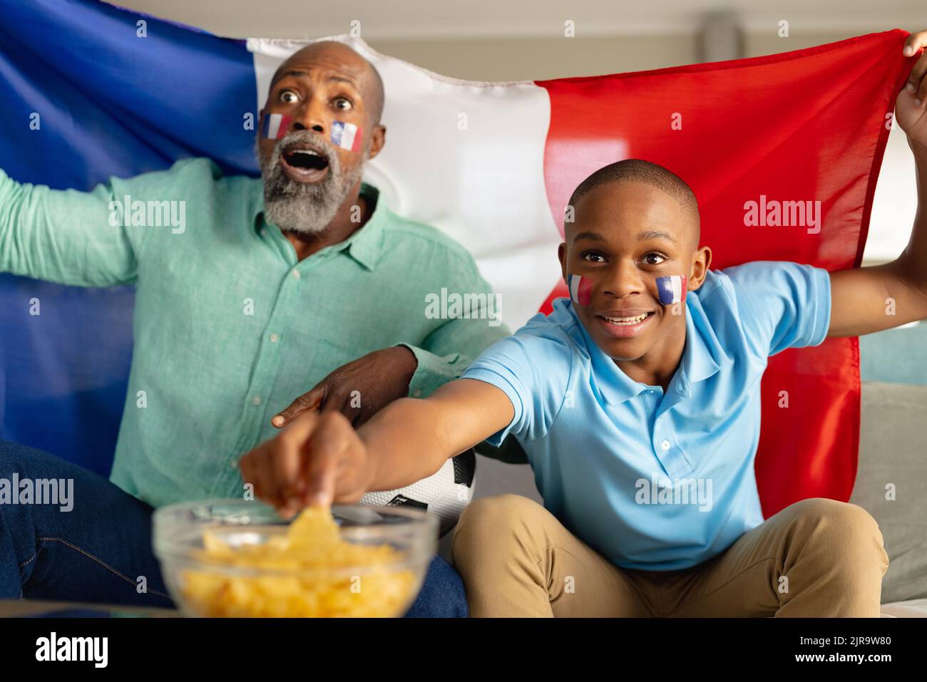 Happy african american male teenager with his father supporting with ...