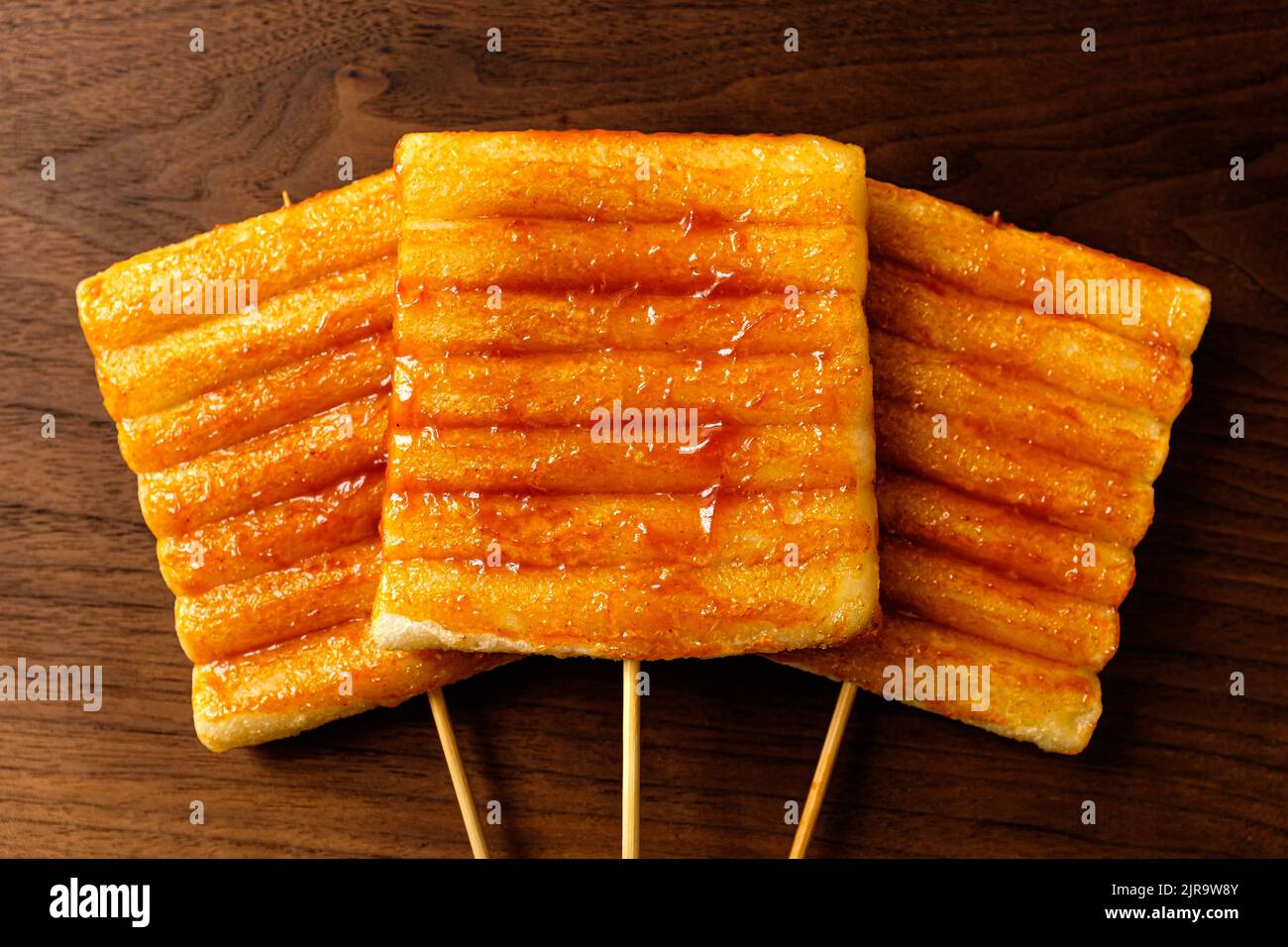 Fried rice cake skewers coated with red pepper paste seasoning Stock ...