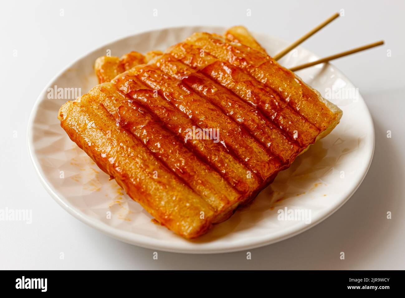 rice cake skewers on a white background Stock Photo - Alamy