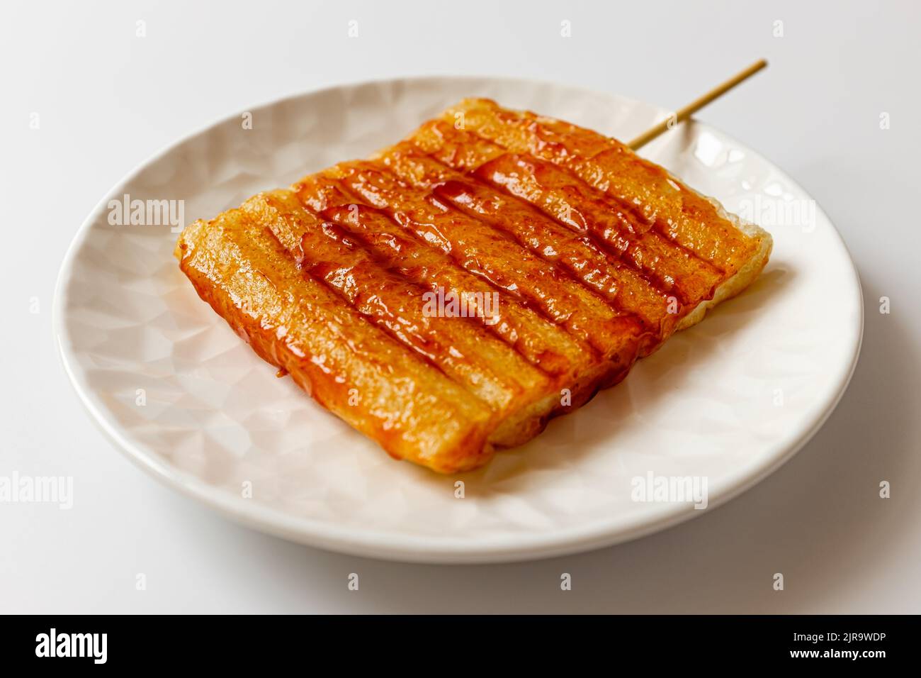 rice cake skewers on a white background Stock Photo - Alamy