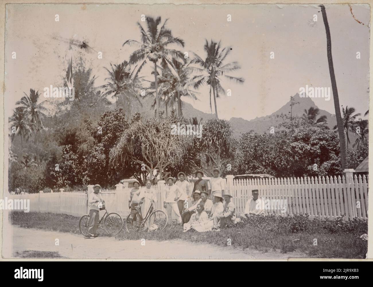 Cook Islanders sitting in front of a white picket fence. From the album ...