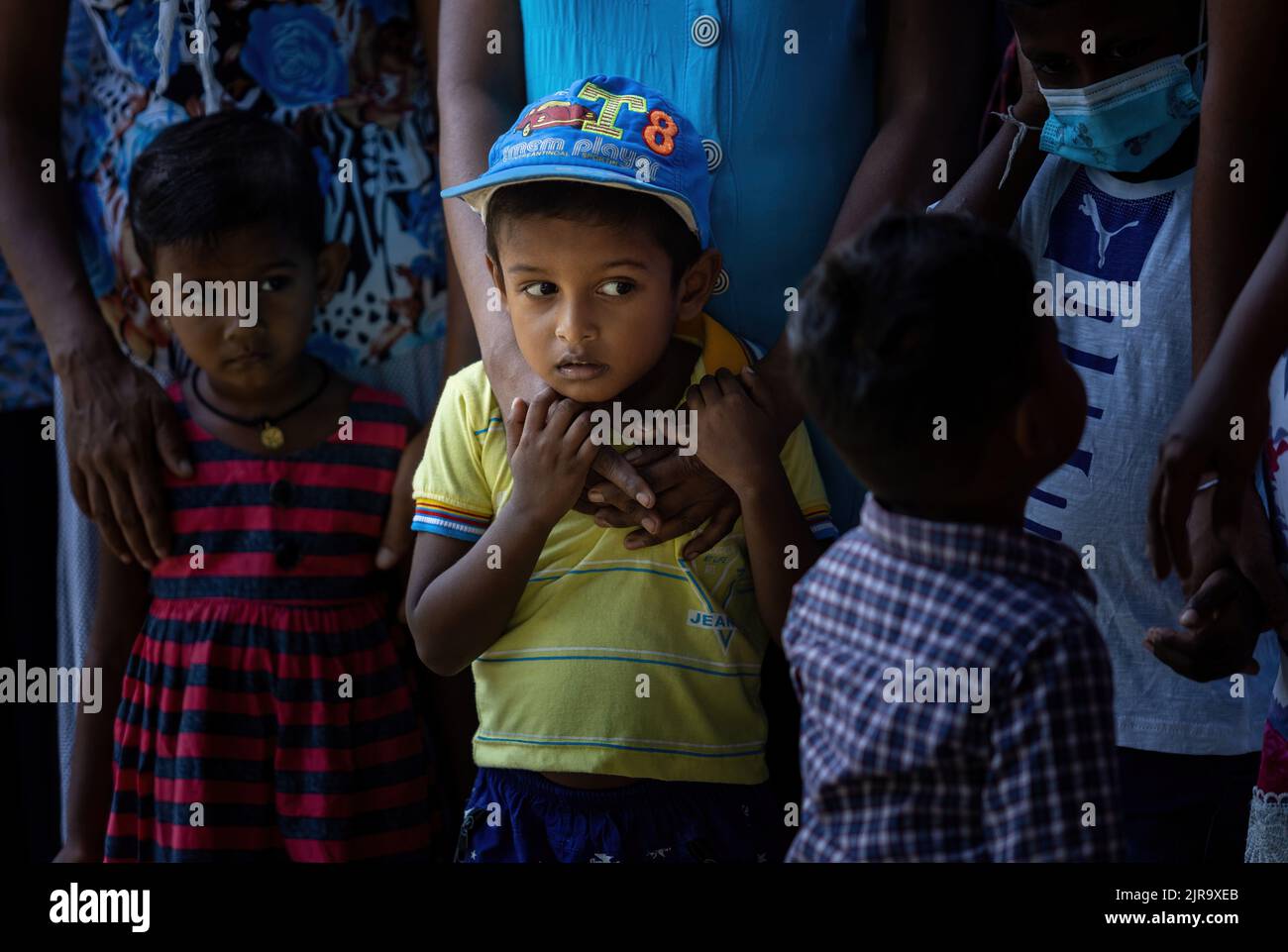 Poor child standing in food queue to receive food parcel in Sri Lanka ...