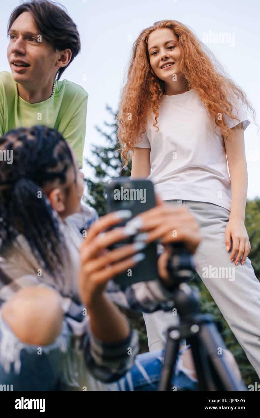 Three bloggers discussing which video to choose from internet so they ...