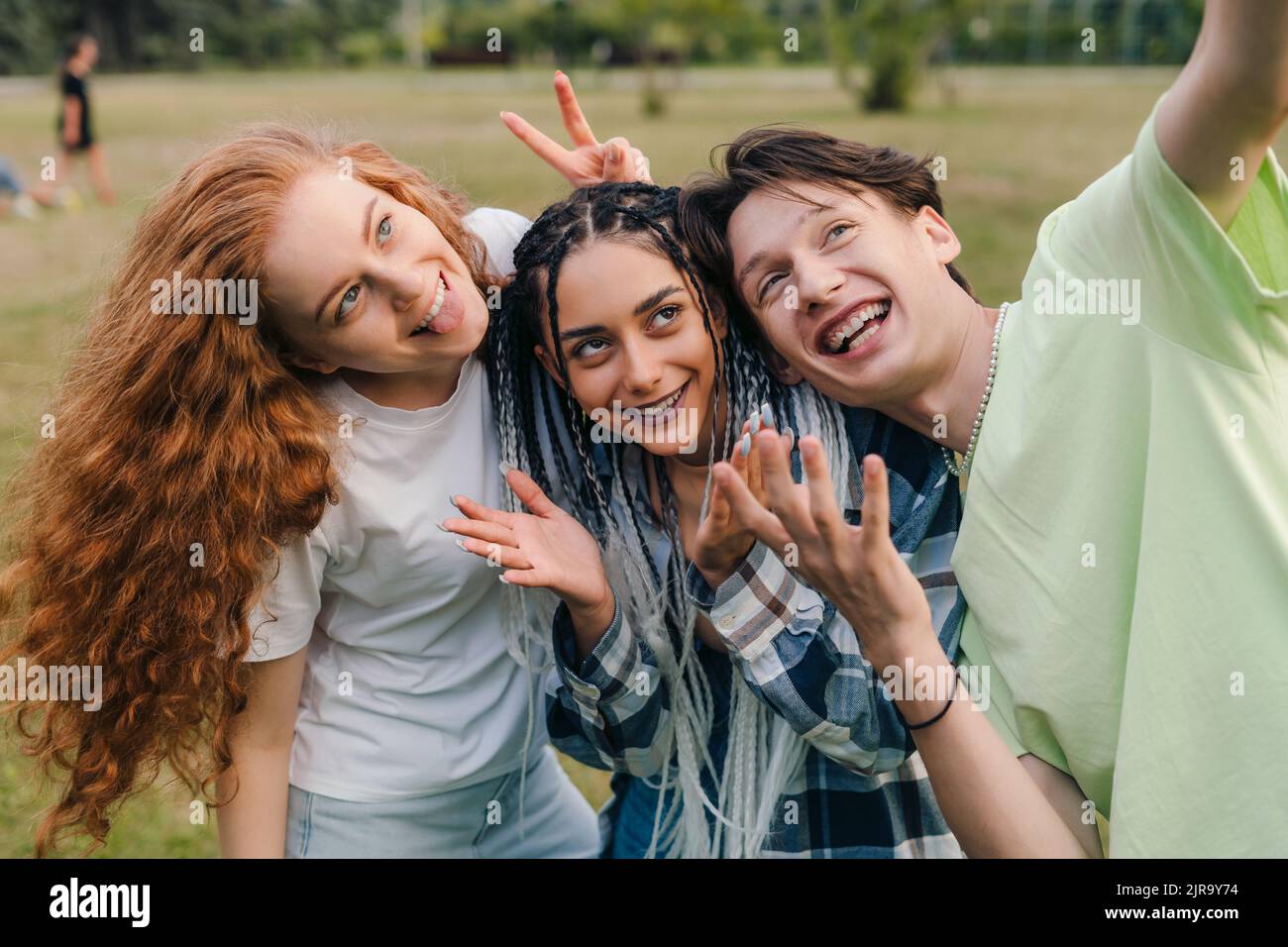 Three teenagers taking selfie for posting in internet, standing in the ...