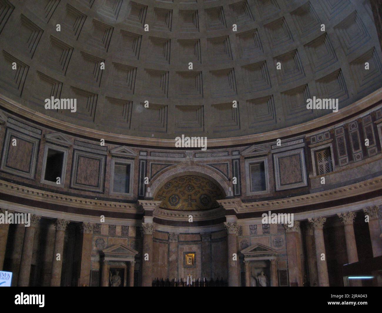 A vertical inside view of a pantheon in Rome with light coming from the ...