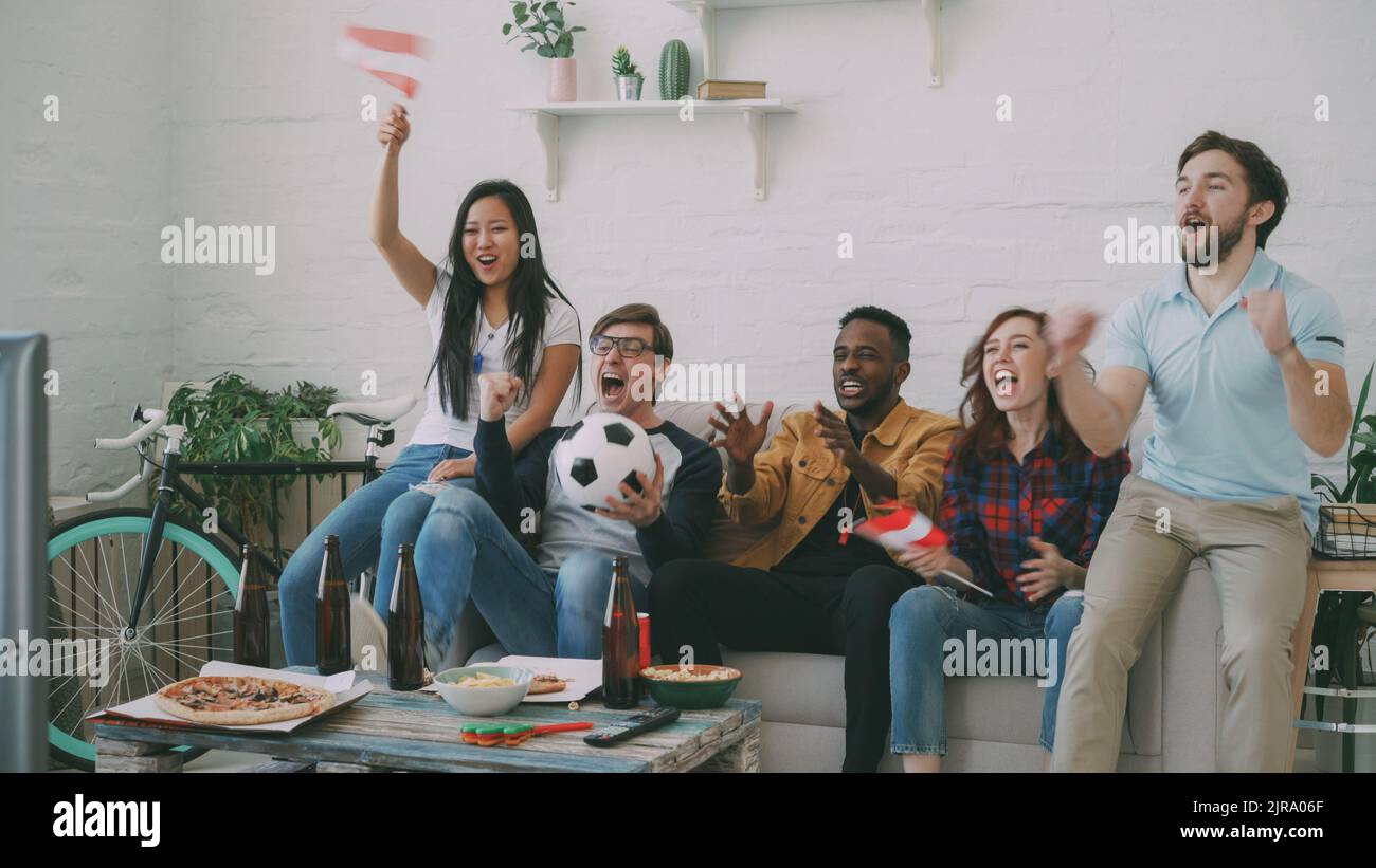 Multi-ethnic group of friends sports fans with Austrian flags watching ...