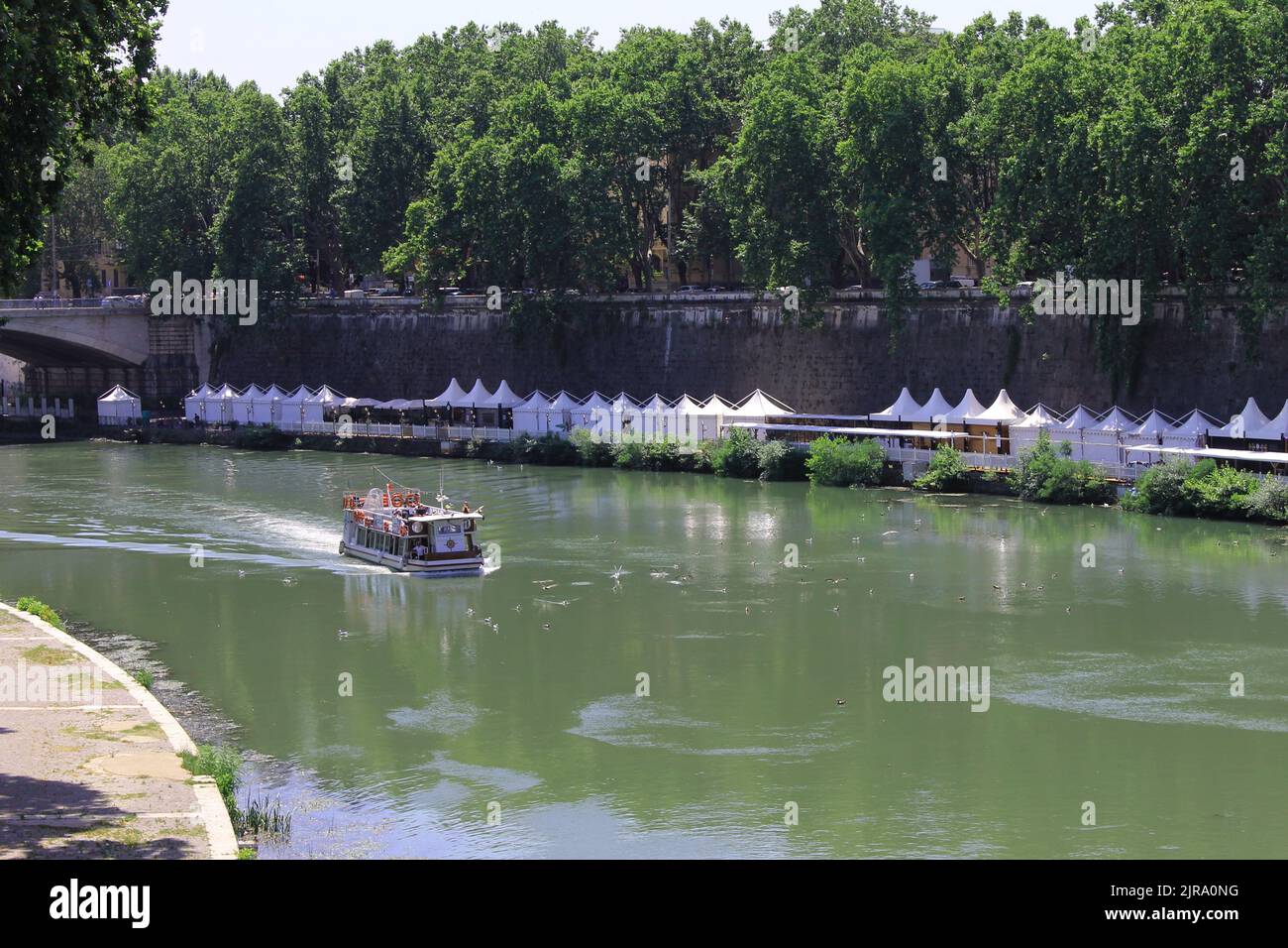 A boat with tourists sailing on the Tiber river in Rome, Italy Stock ...