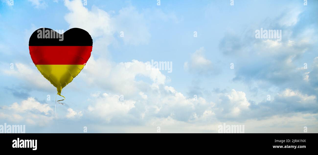 German flag on balloon against sky clouds background. Education ...