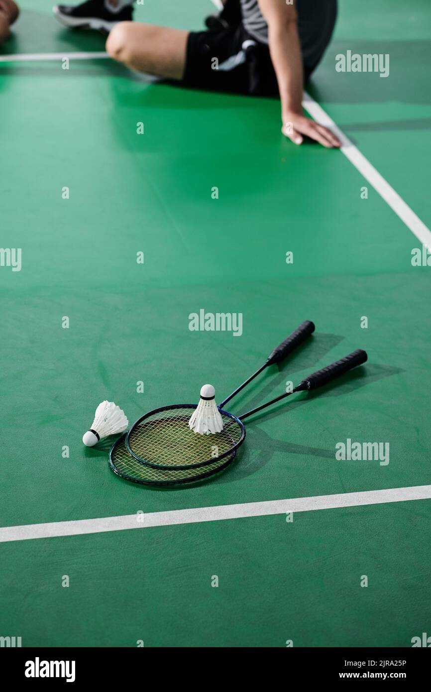 Two badminton rackets and shuttlecocks on floor of court Stock Photo ...