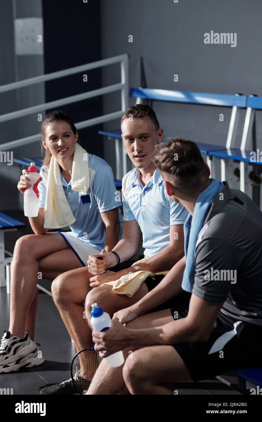 Group of sportsmen discussing badminton game after training Stock Photo ...