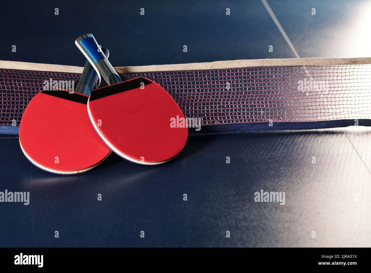 Two rackets and net on ping pong table Stock Photo - Alamy