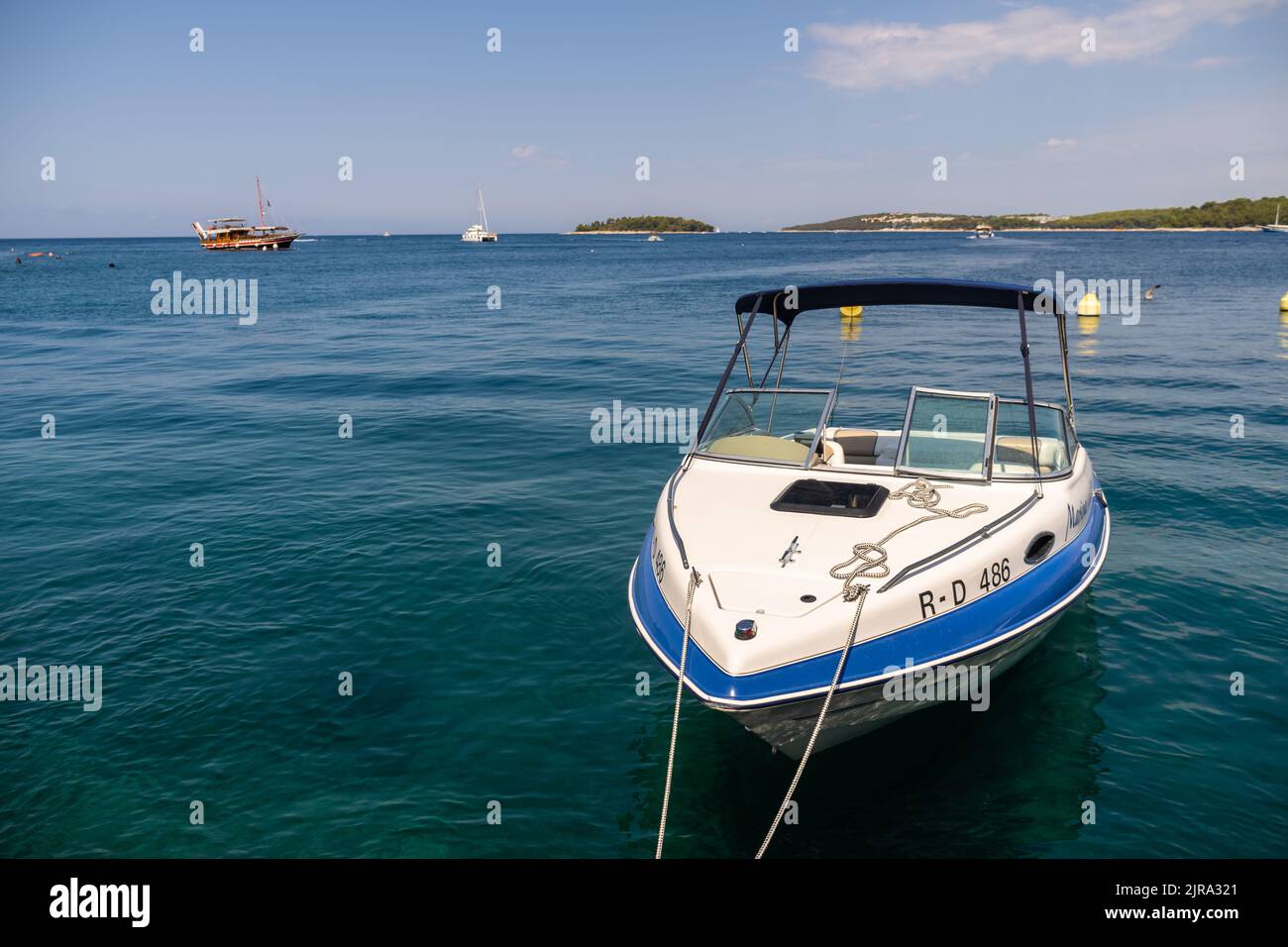 A private boat with rope by the harbor with the background of a ...