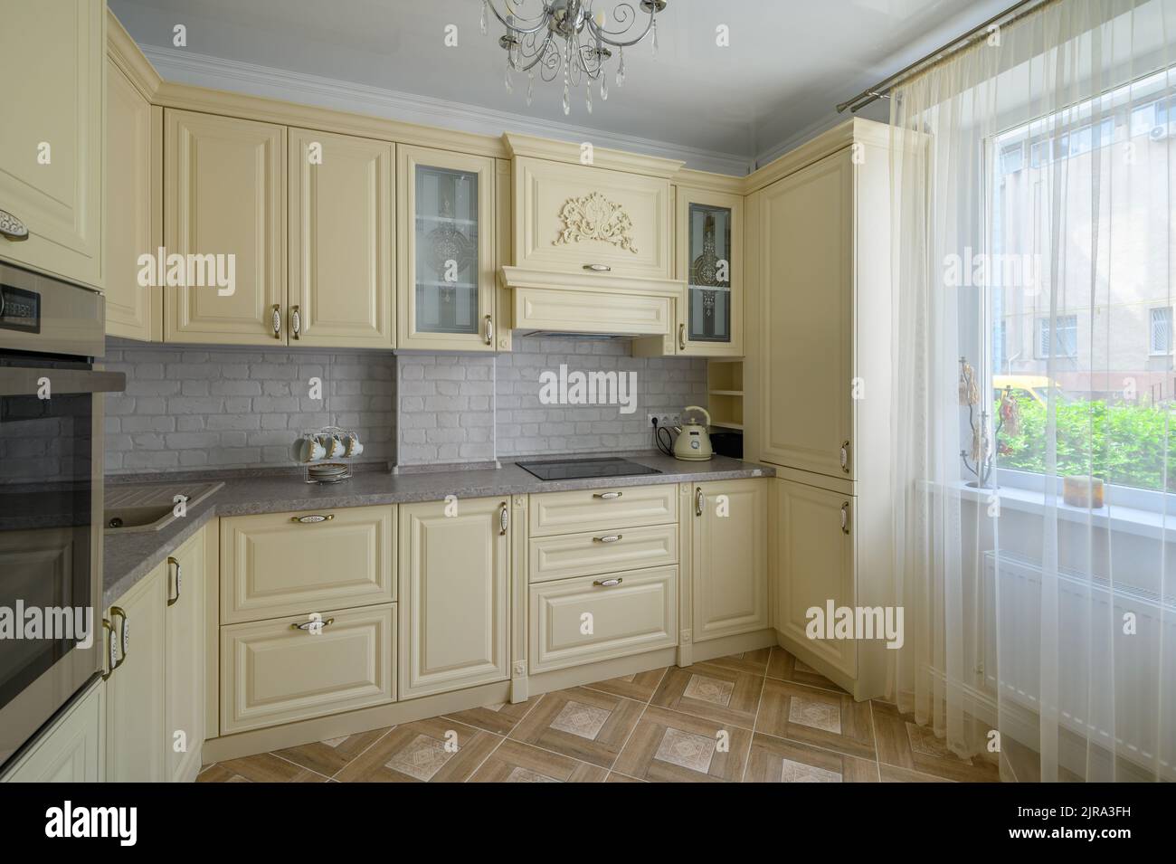 Interior of modern trendy cream colored kitchen Stock Photo - Alamy