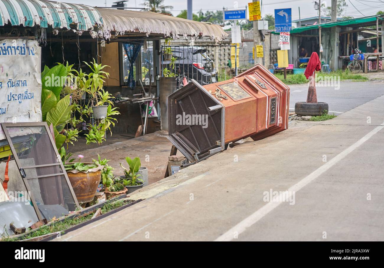 A large post office collection box toppled over on a street, in ...