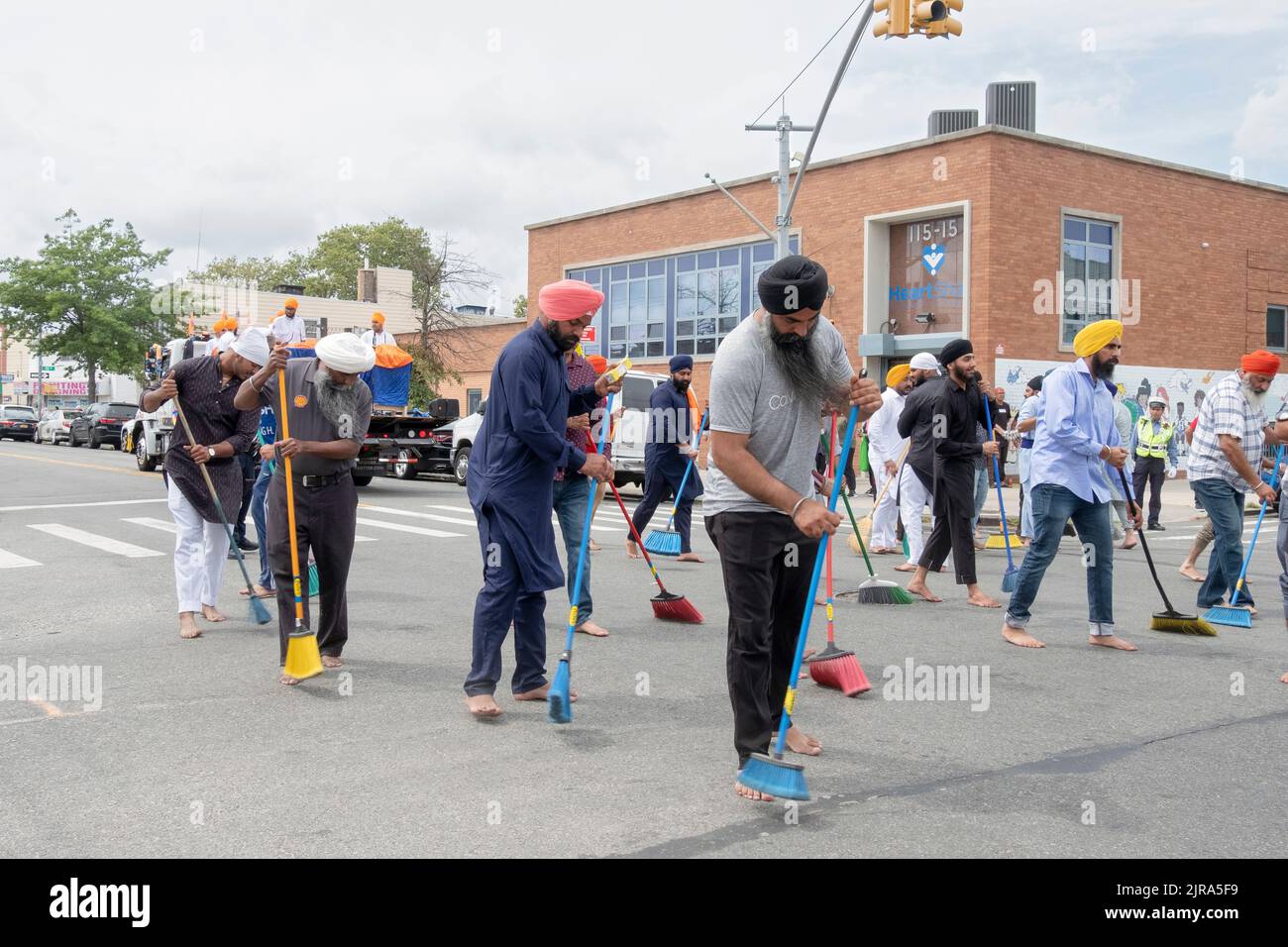 Devout Sikh men & women sweep Liberty Avenue where a parade float carry ...