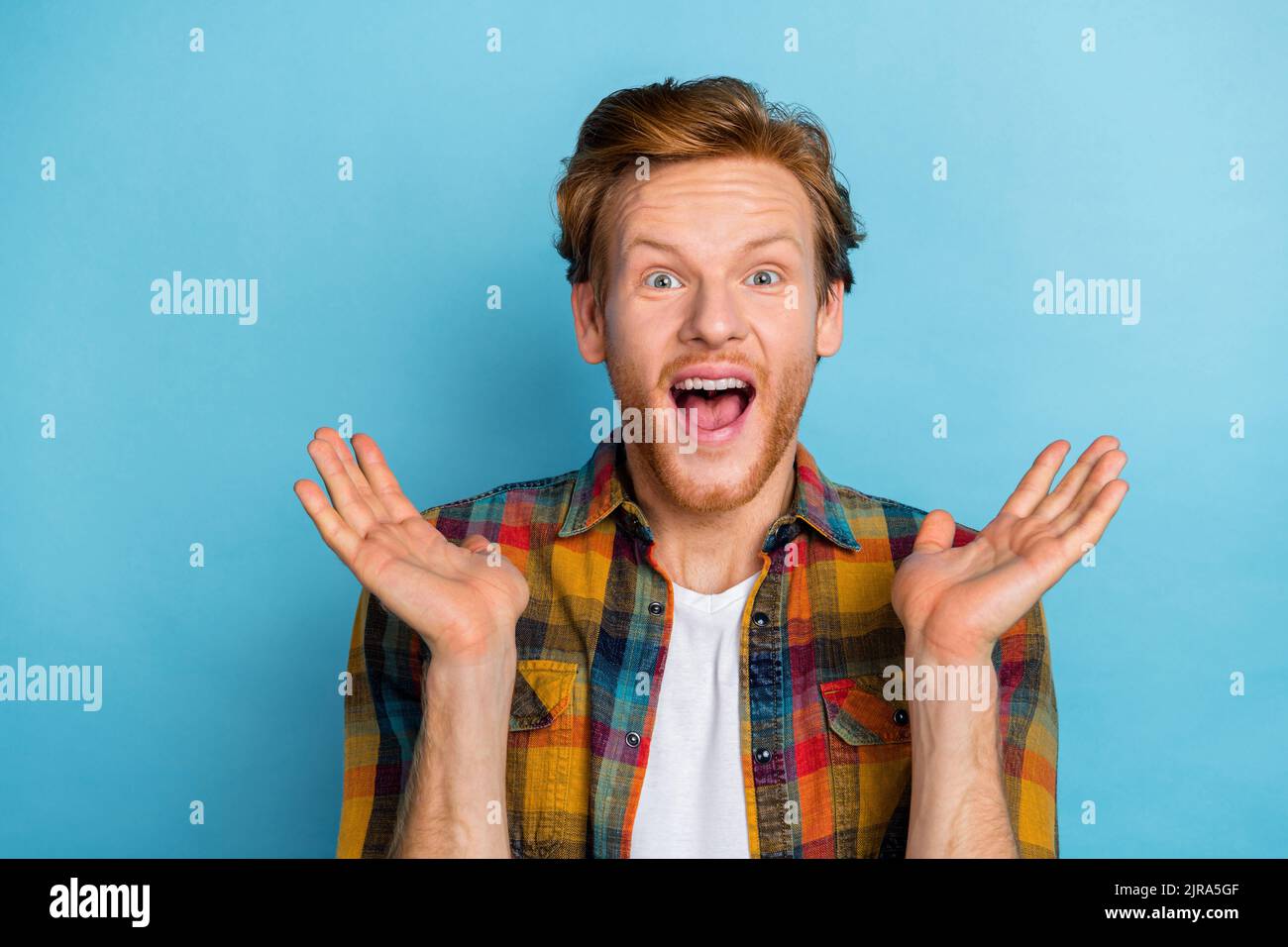 Photo of astonished handsome crazy guy with ginger hair wear plaid ...