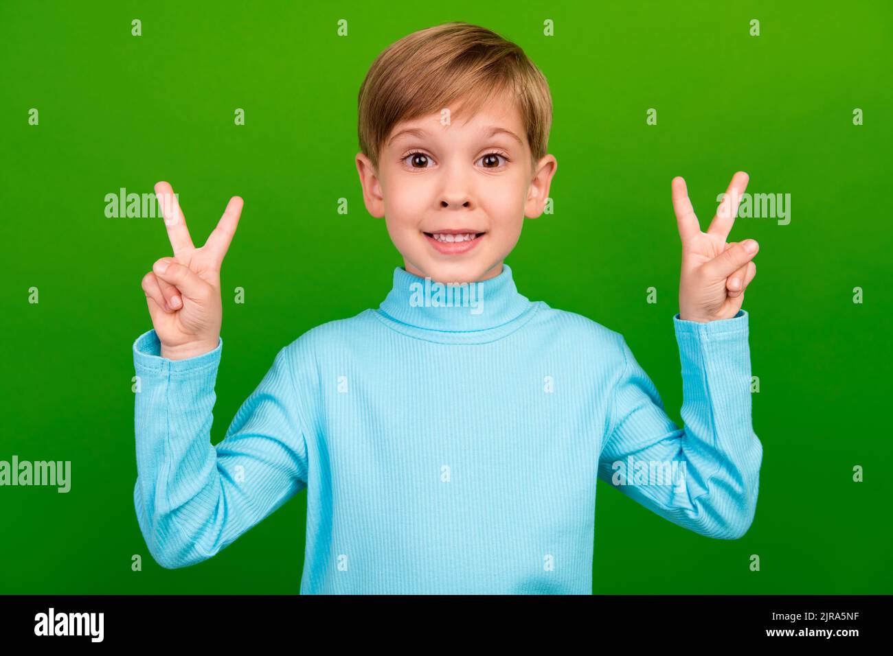 Photo of friendly funny small son wear turquoise turtle neck showing ...