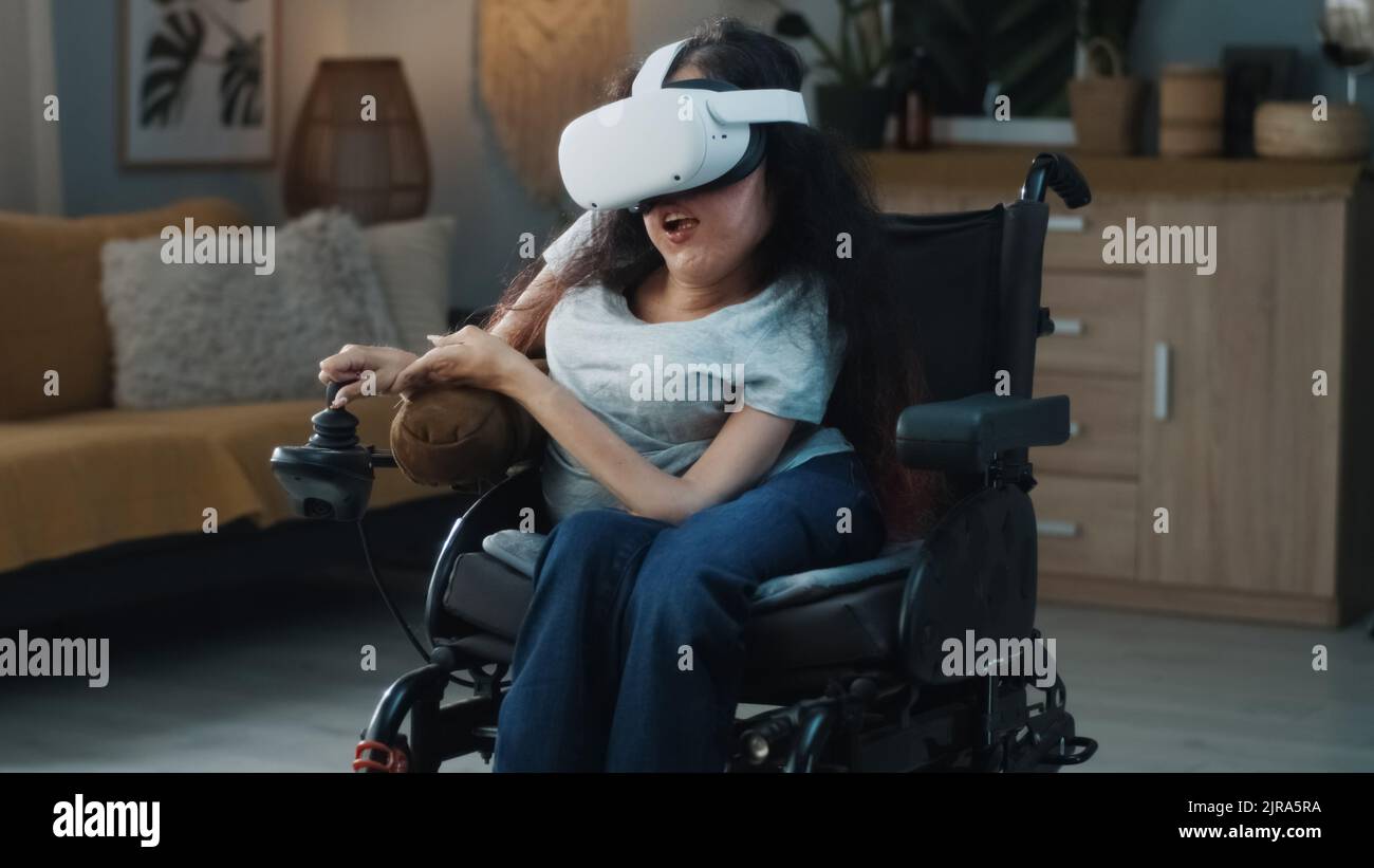 Happy woman with a disability in an electric wheelchair driving around ...