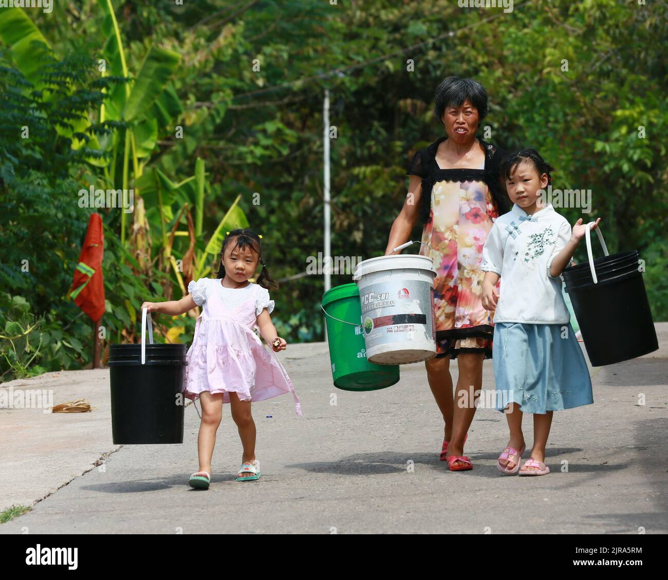 SUINING, CHINA - AUGUST 23, 2022 - Villagers carry water home in ...