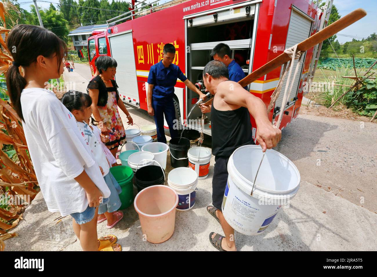SUINING, CHINA - AUGUST 23, 2022 - Villagers carry water home in ...