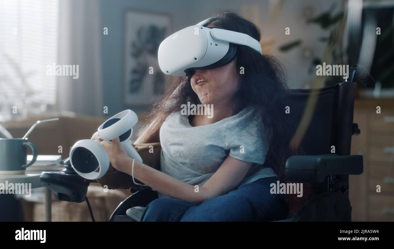 At home woman with disability in a wheelchair wearing virtual reality ...