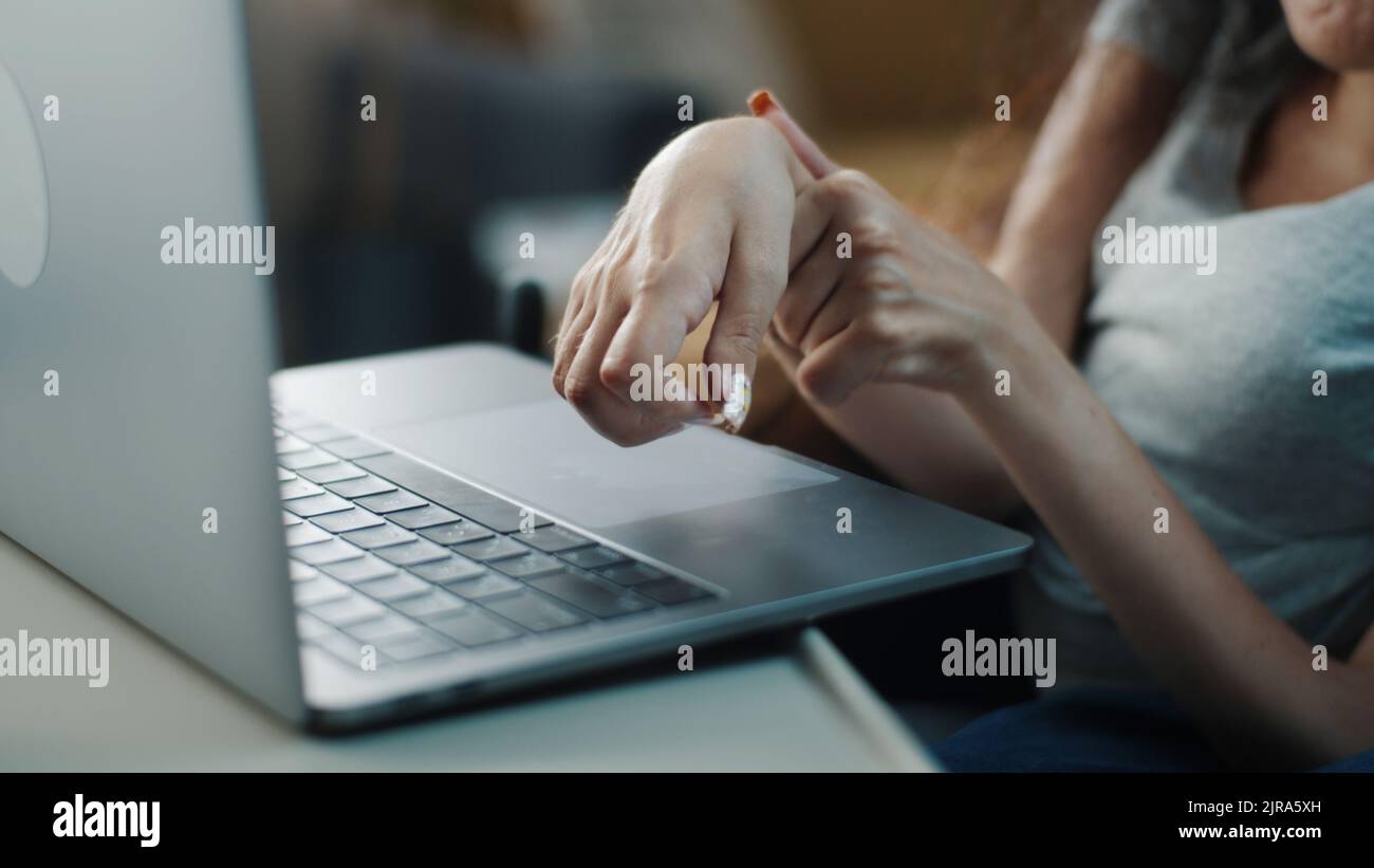 Close shot of the hands of a woman with spinal muscular atrophy surfing ...