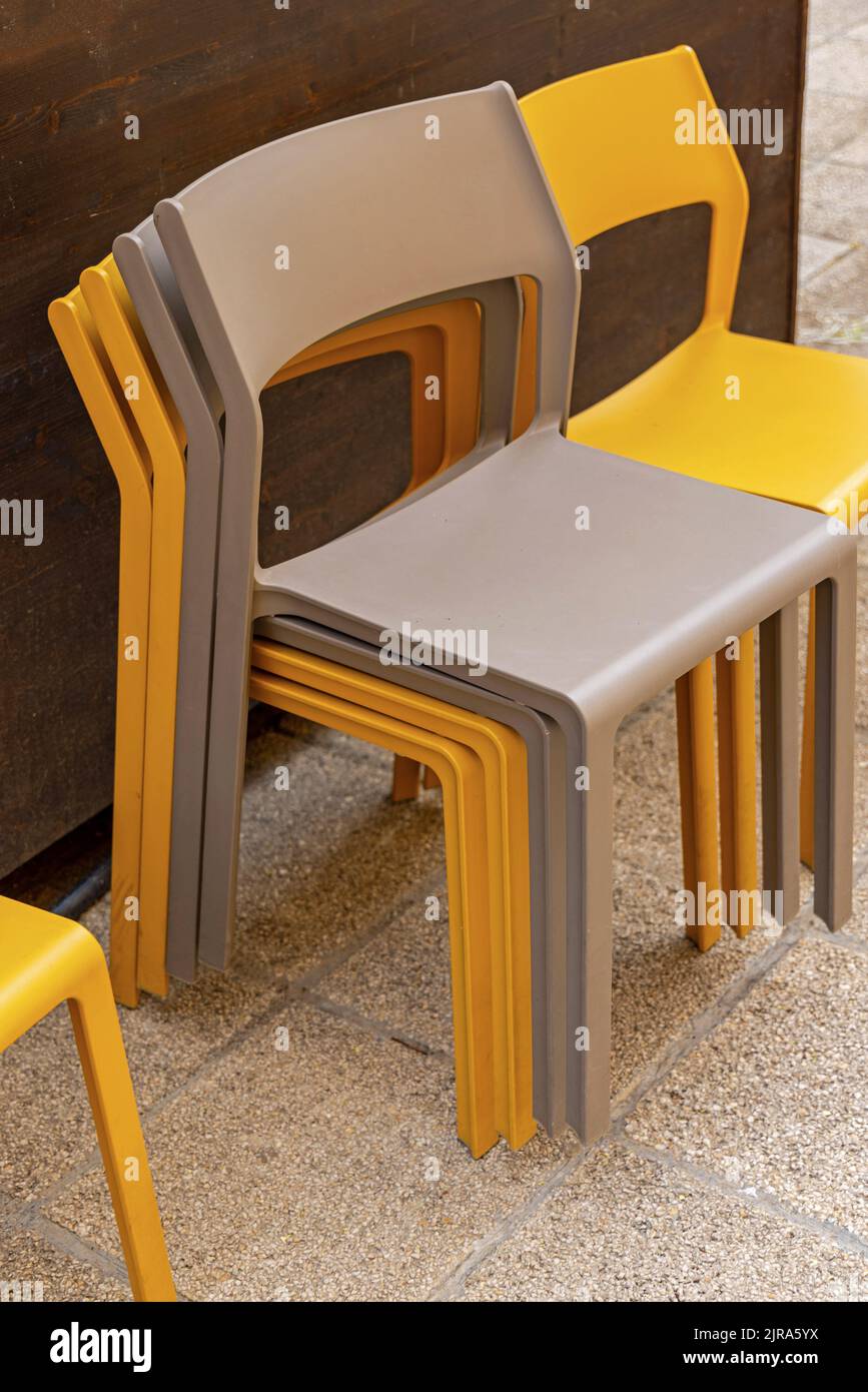 Stack of Plastic Chairs at Outdoor Terrace Patio Tiles Stock Photo - Alamy