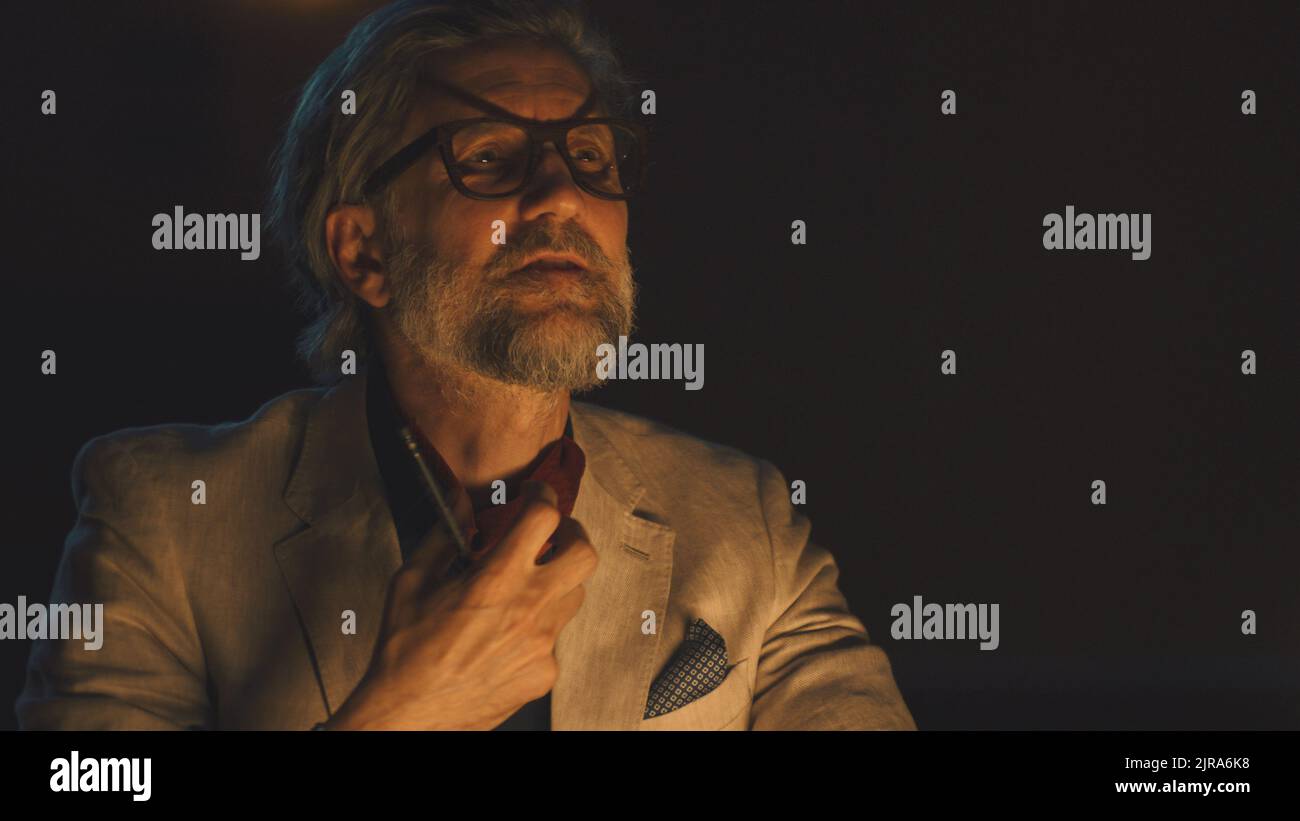 The director in a dim theater with a script in his hand giving ...