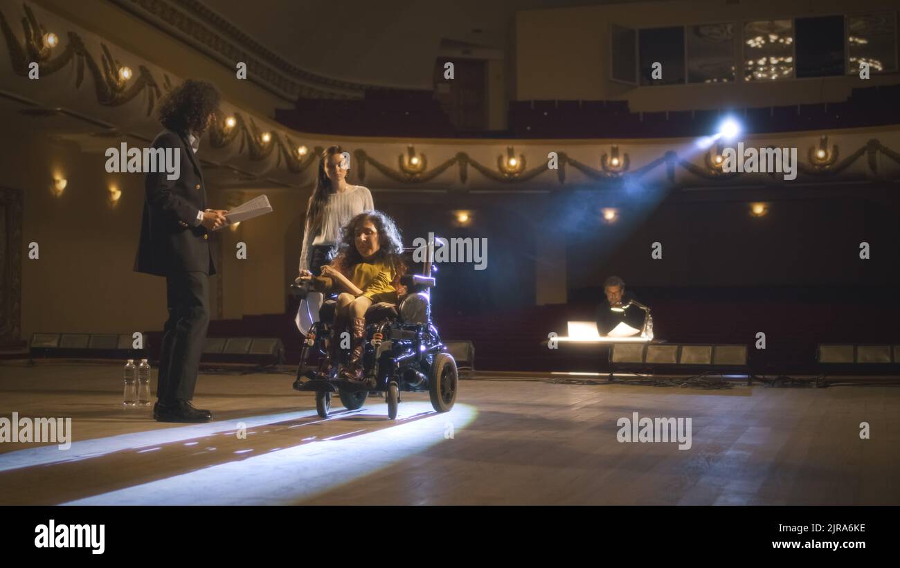 Actress with a disability driving around the stage in an electric ...