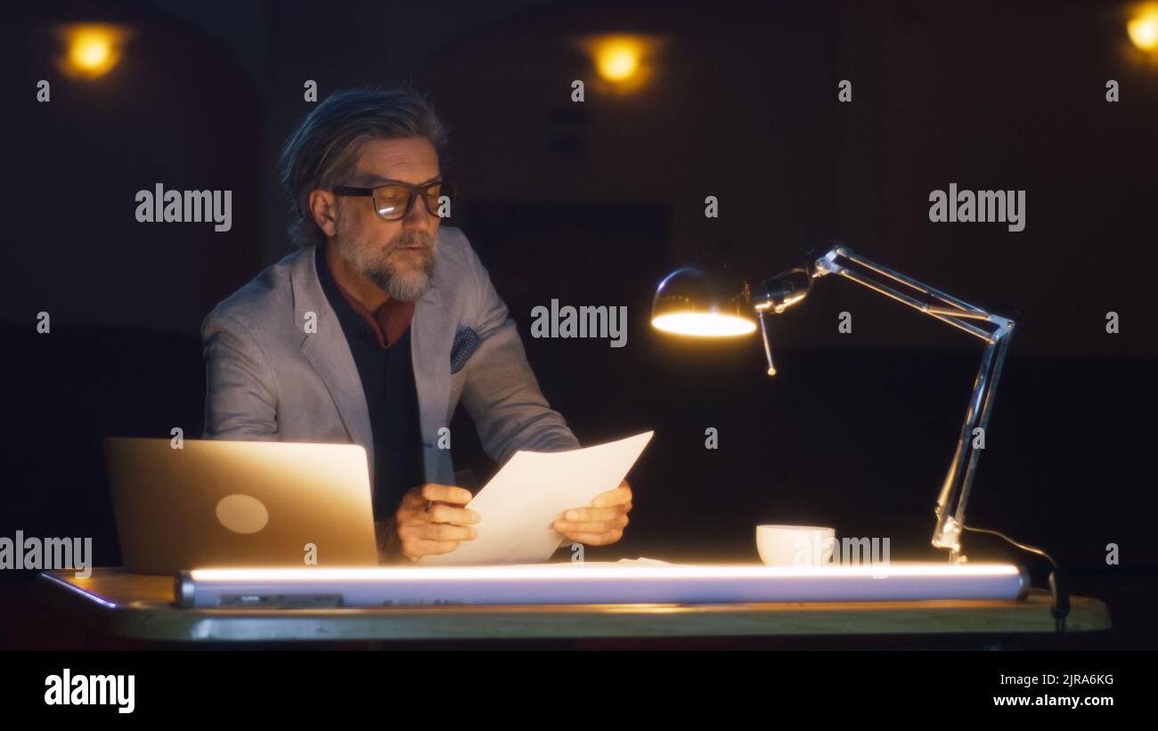 The director in the dark theater reading the script and giving ...