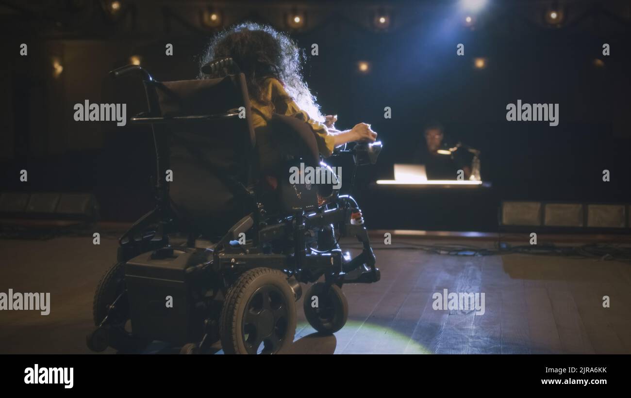 A woman with a disability playing a role on stage during a performance ...