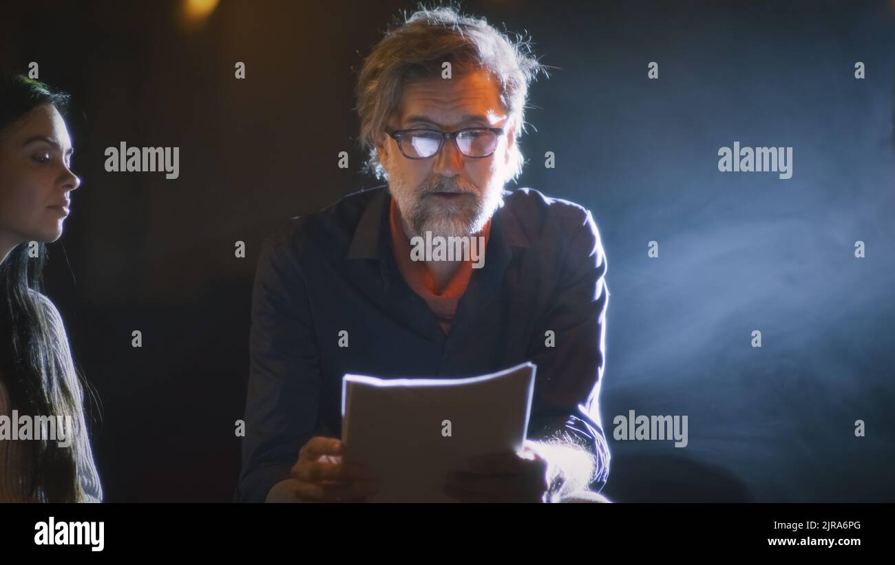 Theater director discussing with the actors the script of the future ...