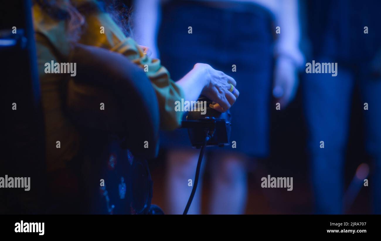 Crop view of an actress with a spinal muscular atrophy, driving an ...