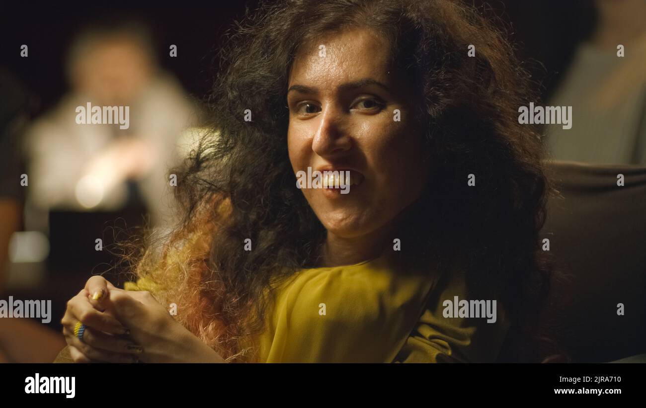 Happy actress with disability in a wheelchair smiling and looking at ...