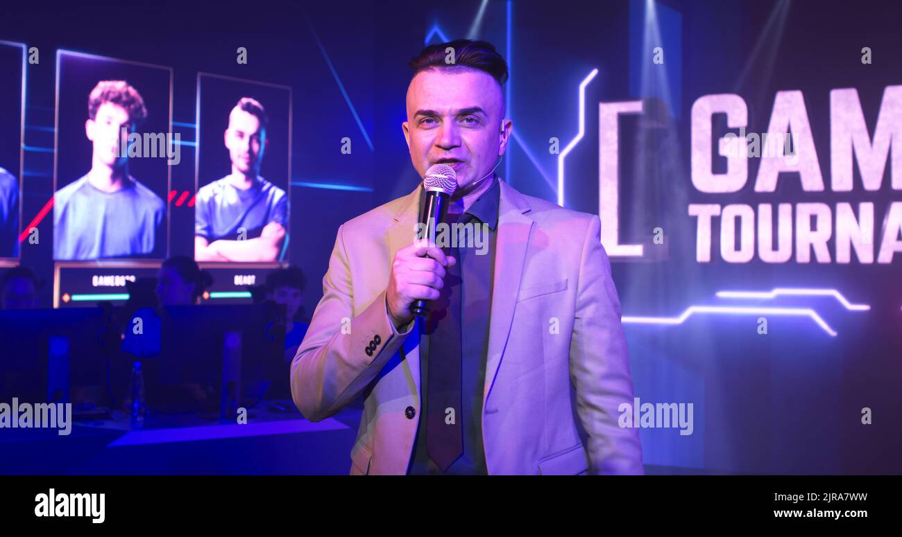 Excited adult announcer speaking to camera at start of professional ...