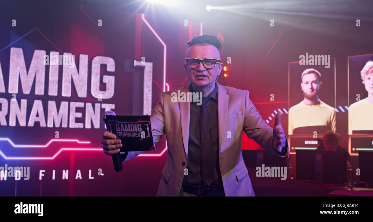 Excited adult announcer speaking to camera at start of professional ...