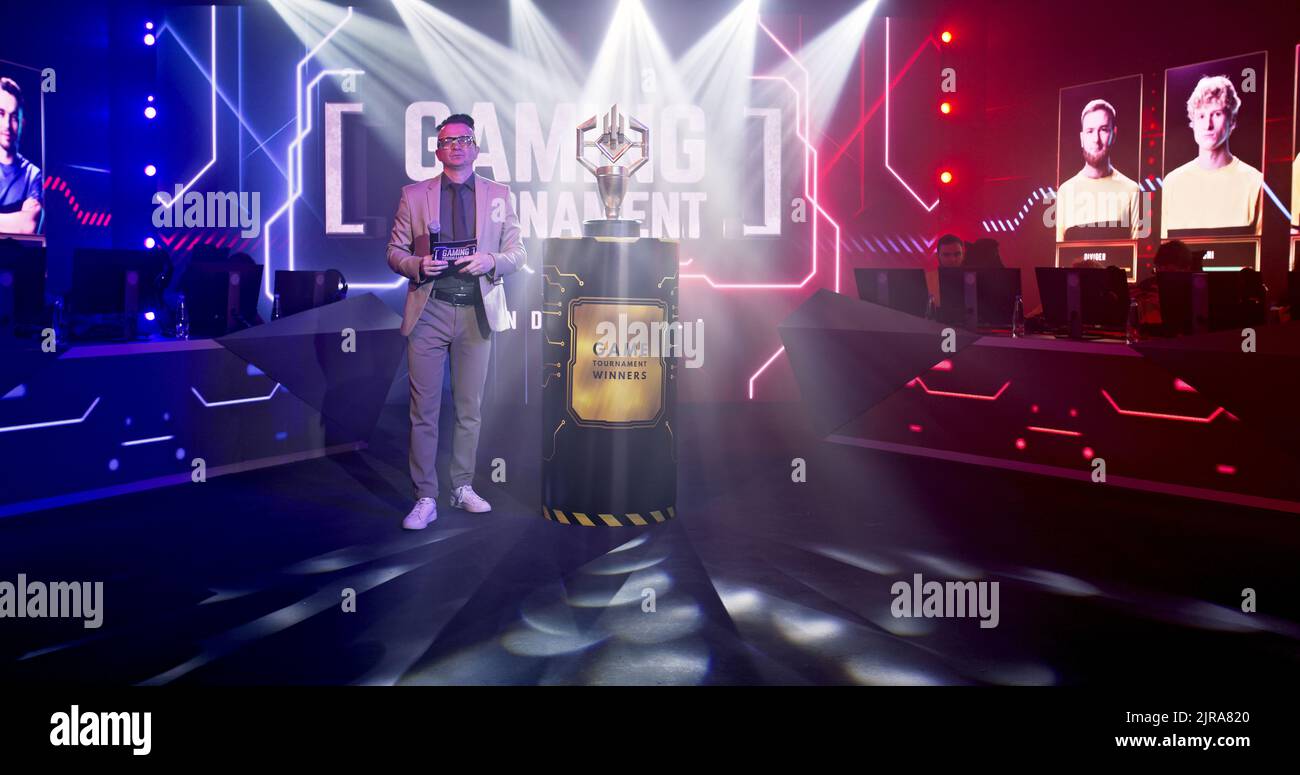 Man host with microphone walking and talking to audience while ...